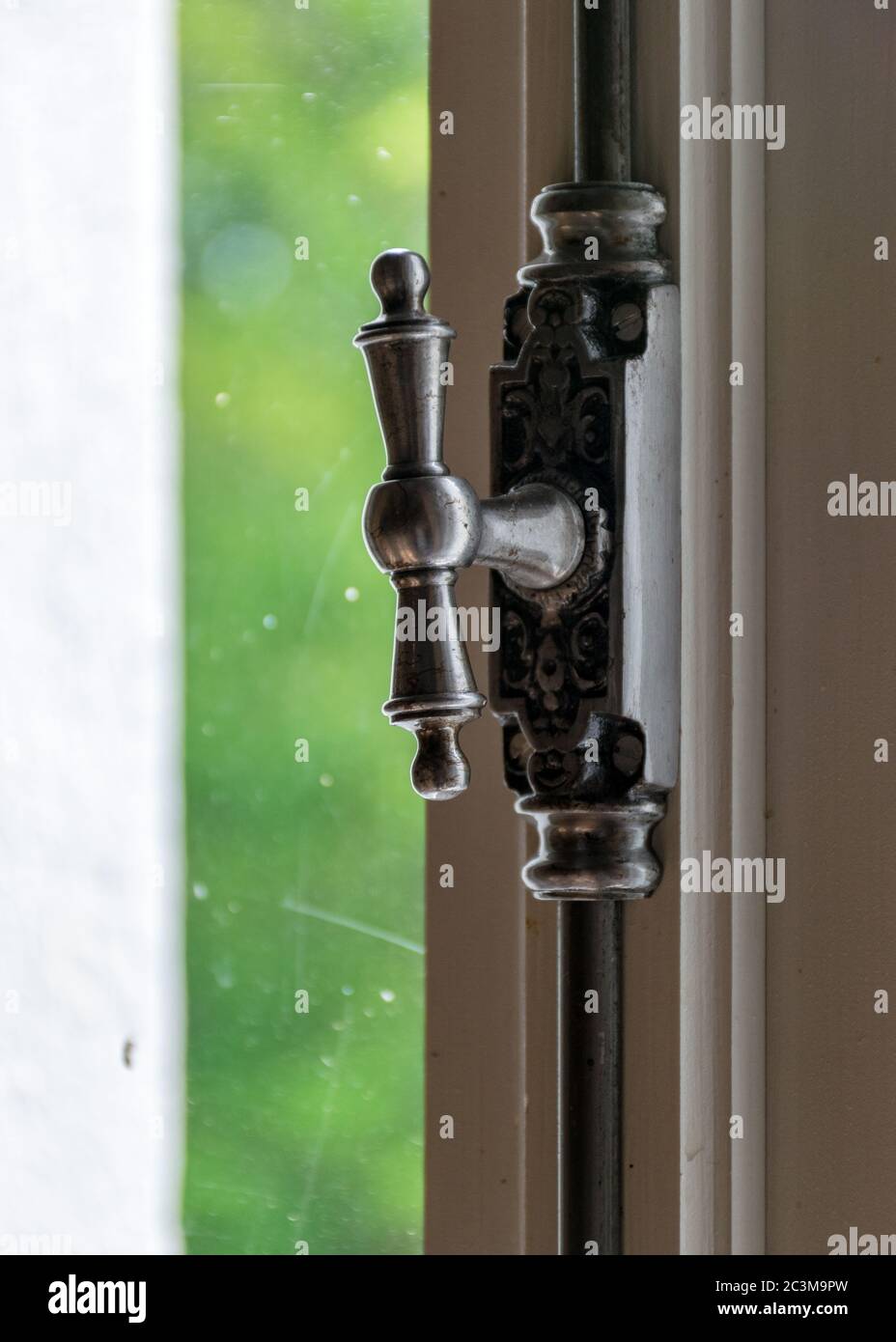 photo with ancient window opening handle, white old wooden window frame ...