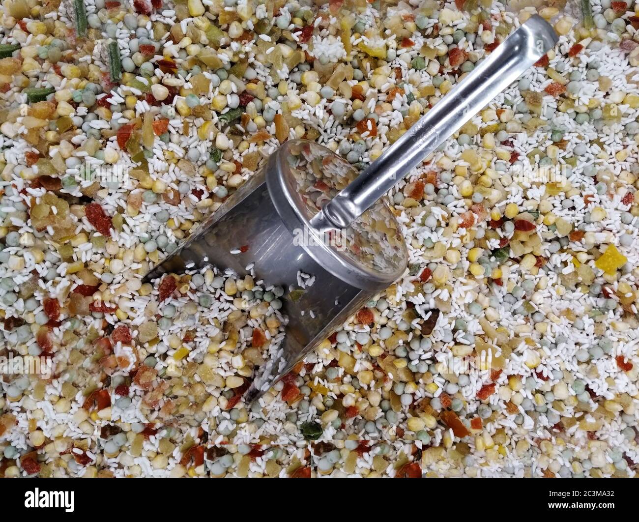 shovel in frozen rice and vegetables flat lay. Semi-product concept ...