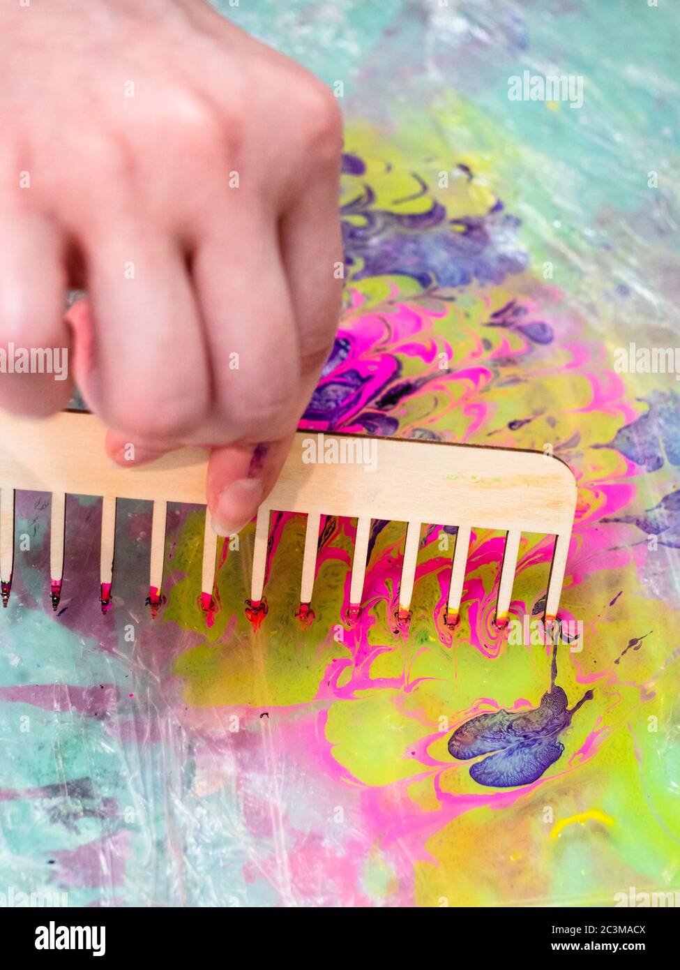 workshop of Ebru paper marbling - mixing of dyes with wooden comb on ...