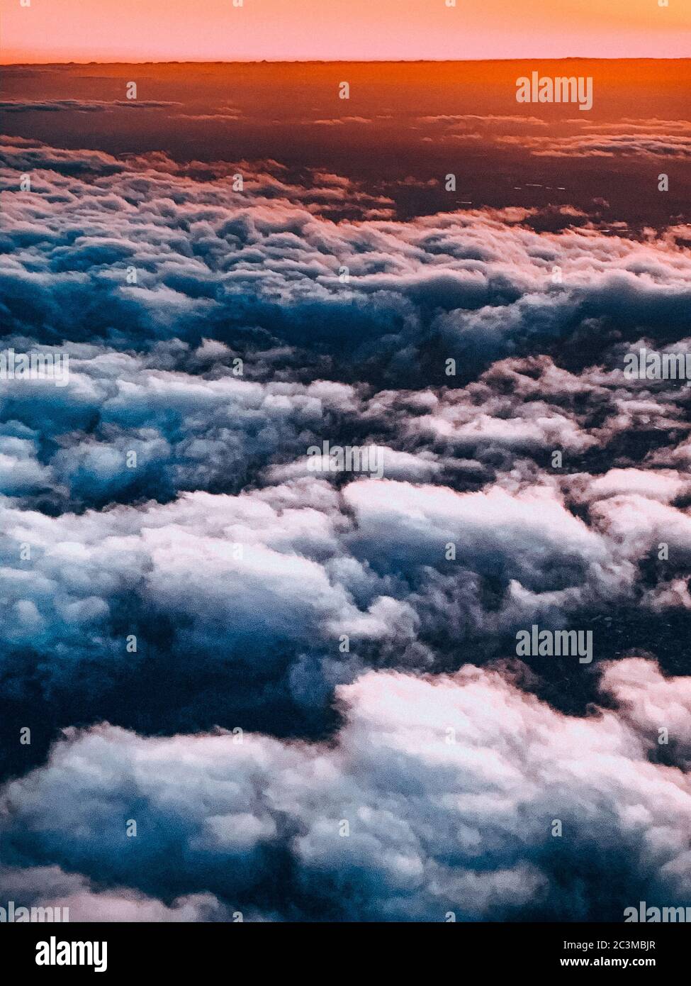 Vertical high angle shot of the breathtaking clouds in the sky captured ...