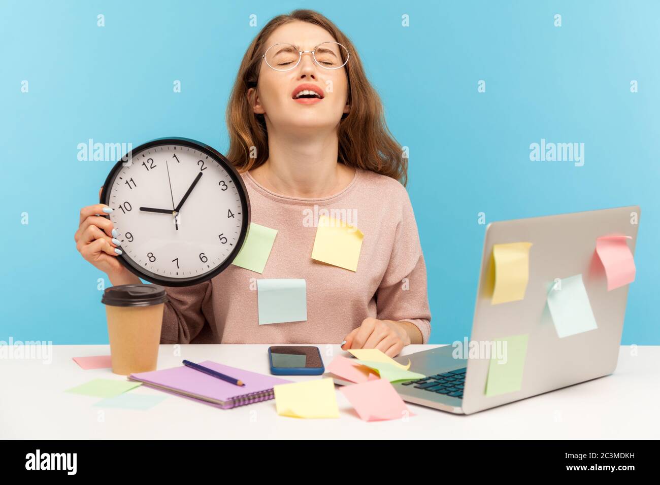 Overtime work. Fatigued upset woman employee sitting at workplace ...