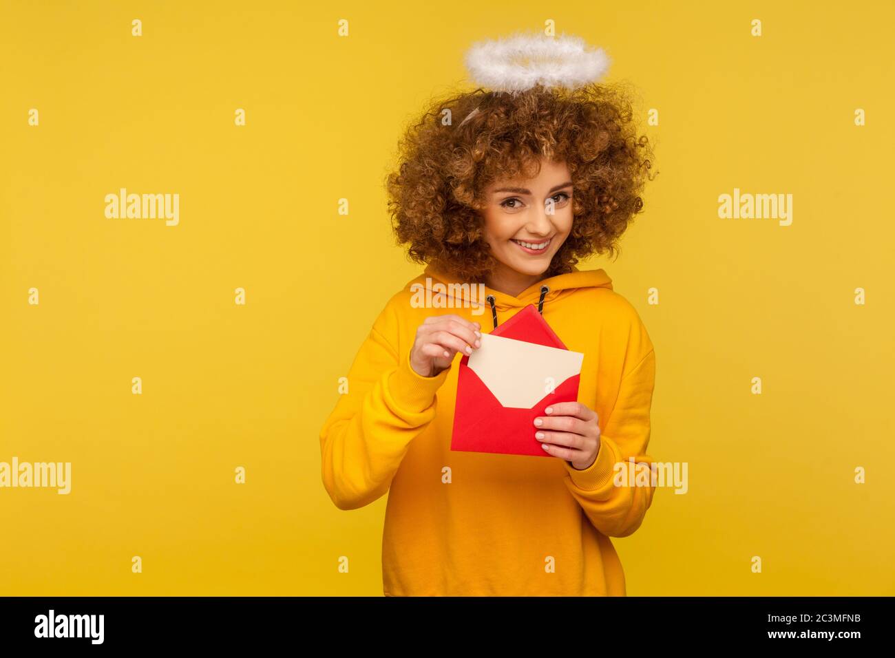 Love message. Portrait of happy curly-haired angelic woman with saint ...
