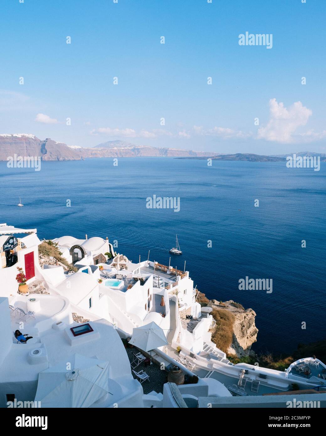 Vertical high angle shot of the white buildings in Santorini, Greece ...