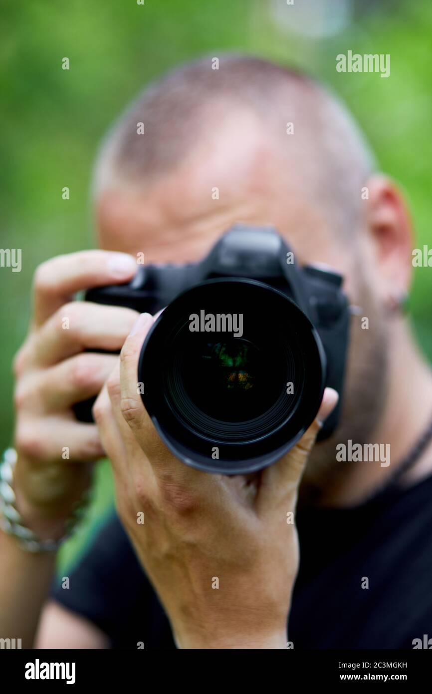 Portrait photographer covering face camera hi-res stock photography and ...