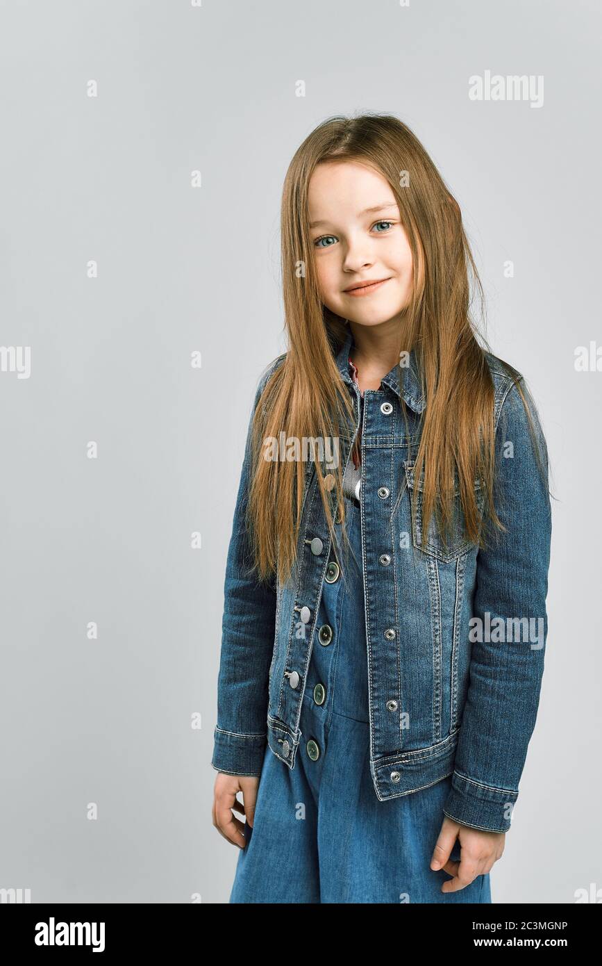 portrait of a cute little girl. gray studio background Stock Photo - Alamy