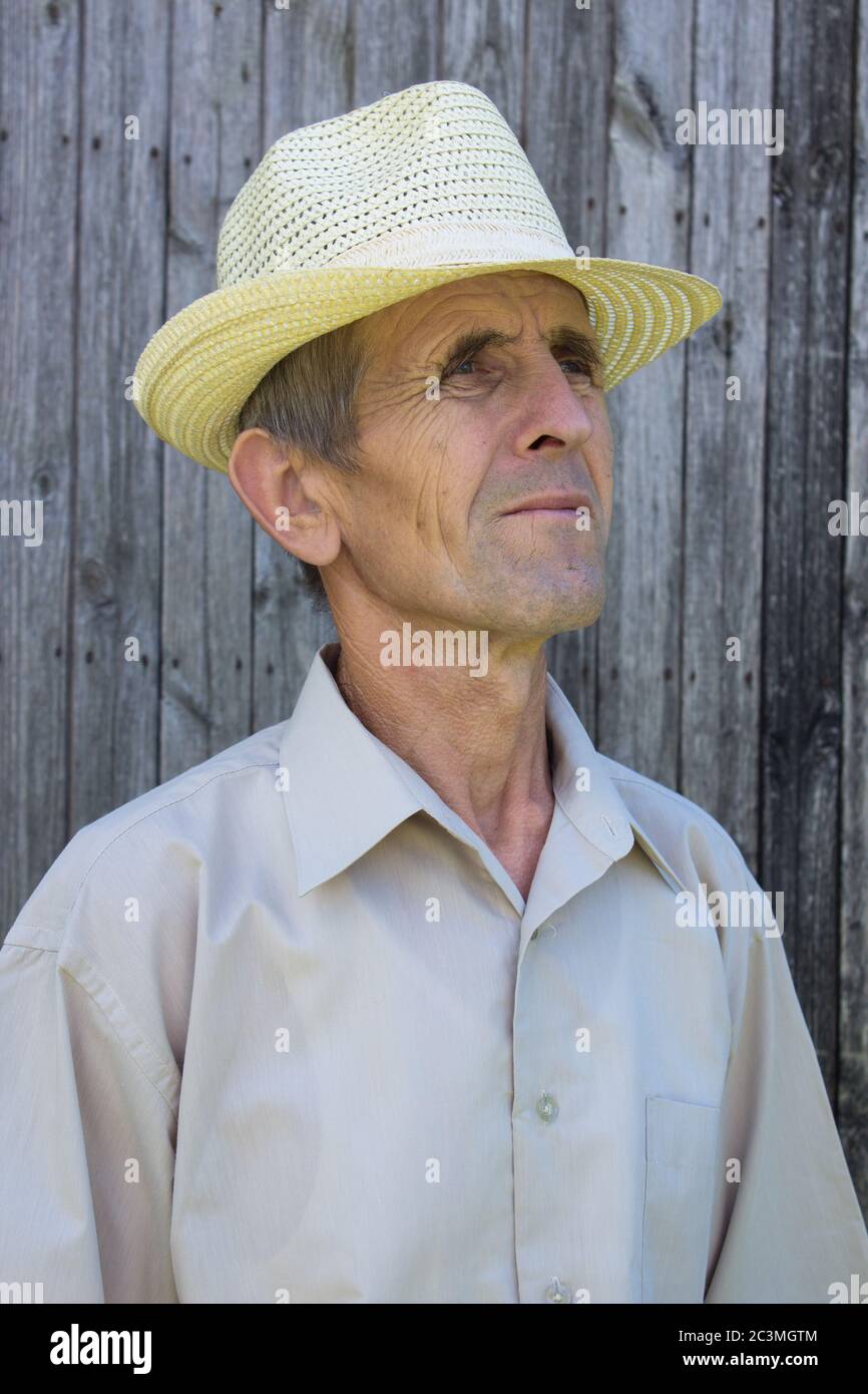 portrait of retired farmer in hat on wooden barn background Stock Photo ...