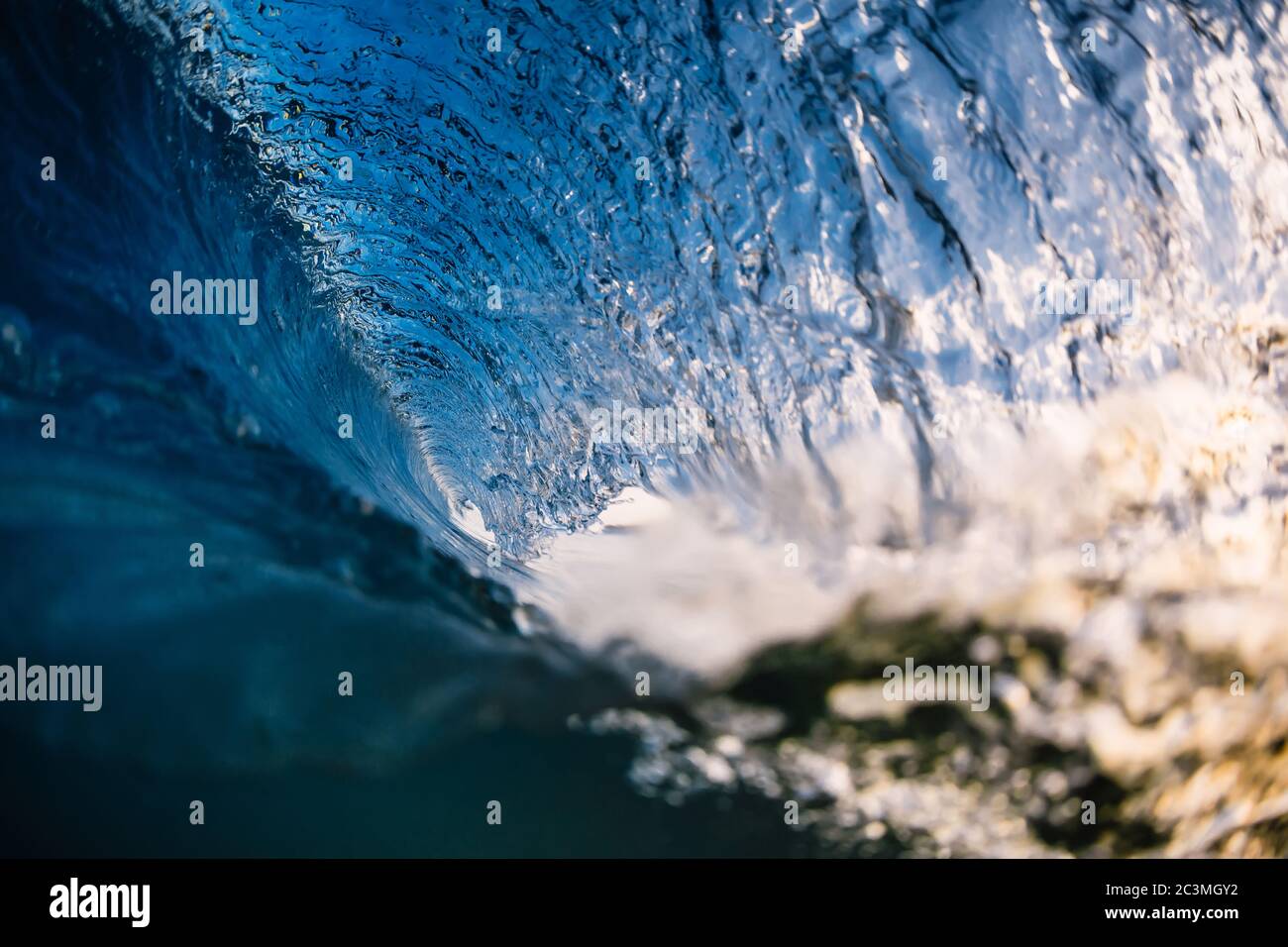 In barrel wave with sunrise tones. Breaking ocean wave Stock Photo - Alamy
