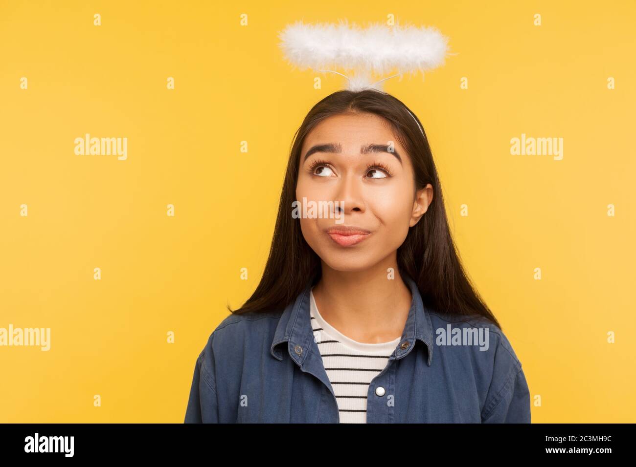 I'm angel! Portrait of thoughtful girl looking at nimbus over her head ...