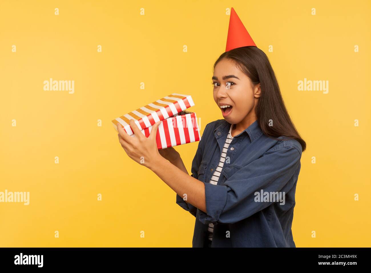 Wow, amazing present! Portrait of shocked excited girl in denim shirt ...