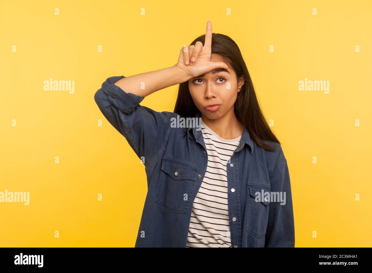 I lost! Portrait of unlucky sad girl in denim shirt standing with loser ...