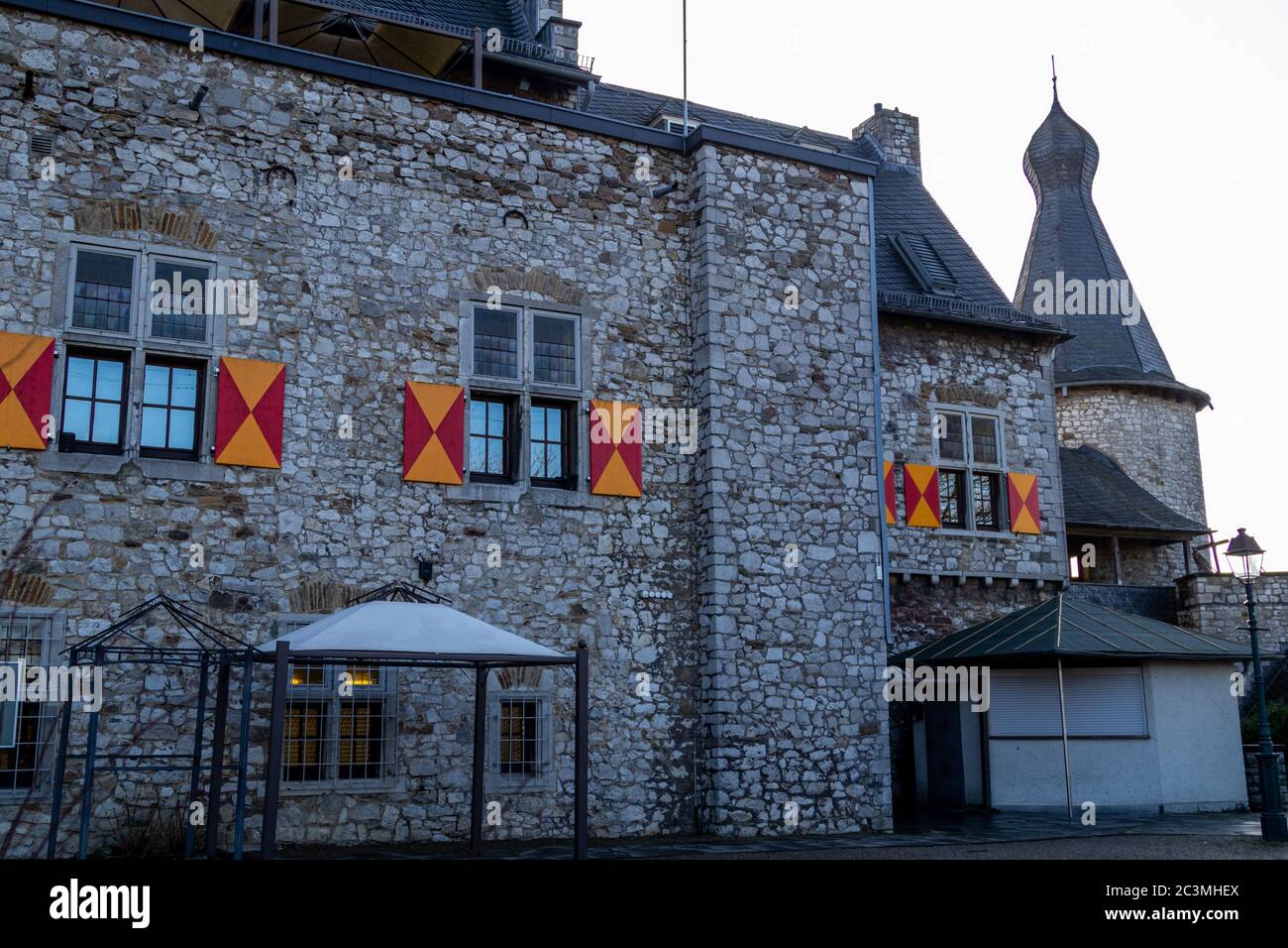 View at a building of Stolberg castle with red orange window shutters ...