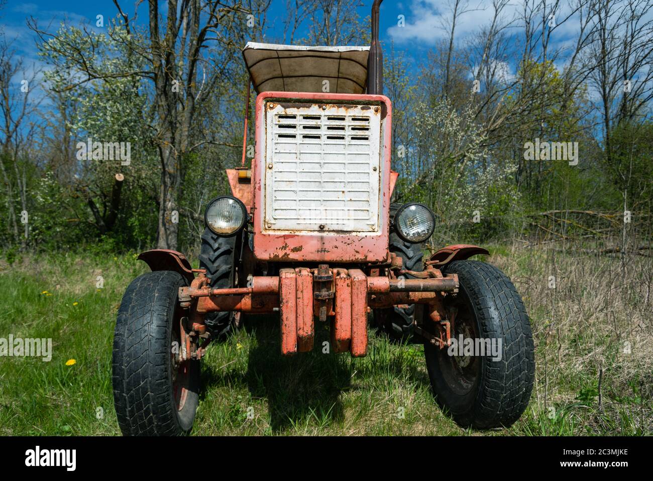 Old fashioned tractor on a field Stock Photo - Alamy