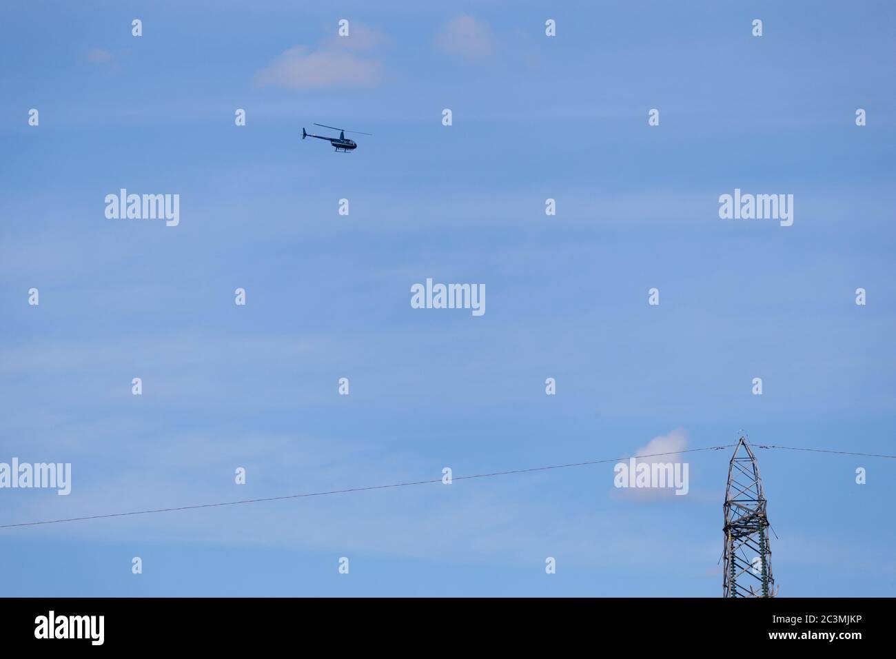 A helicopter checking power lines of the National Grid Stock Photo - Alamy