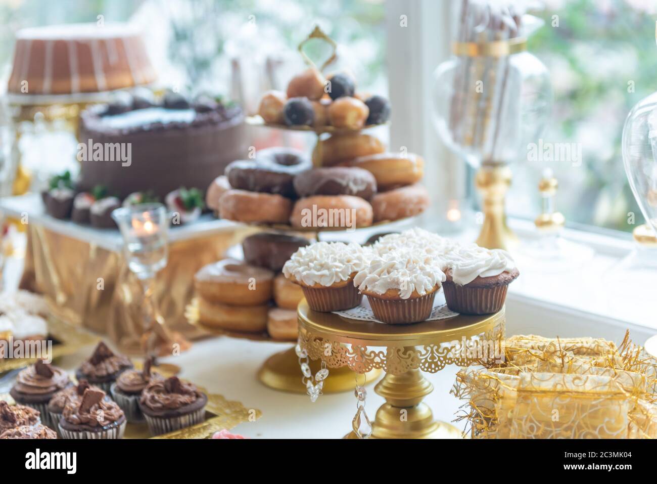 Beautiful wedding table setup with sweet donuts and chocolate cake ...