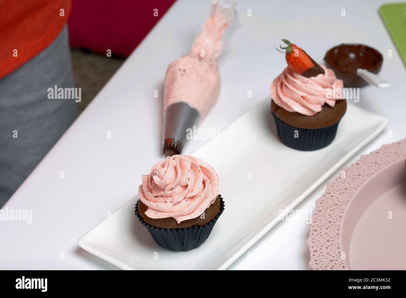 Chocolate cupcakes with strawberry cream. Decorated with half ...