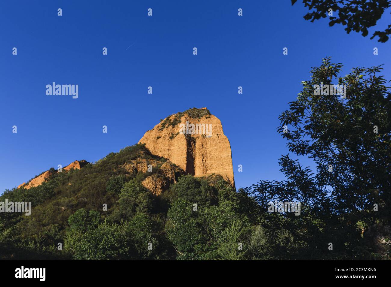 Rock with light falling on it and a blue sky over it Stock Photo - Alamy