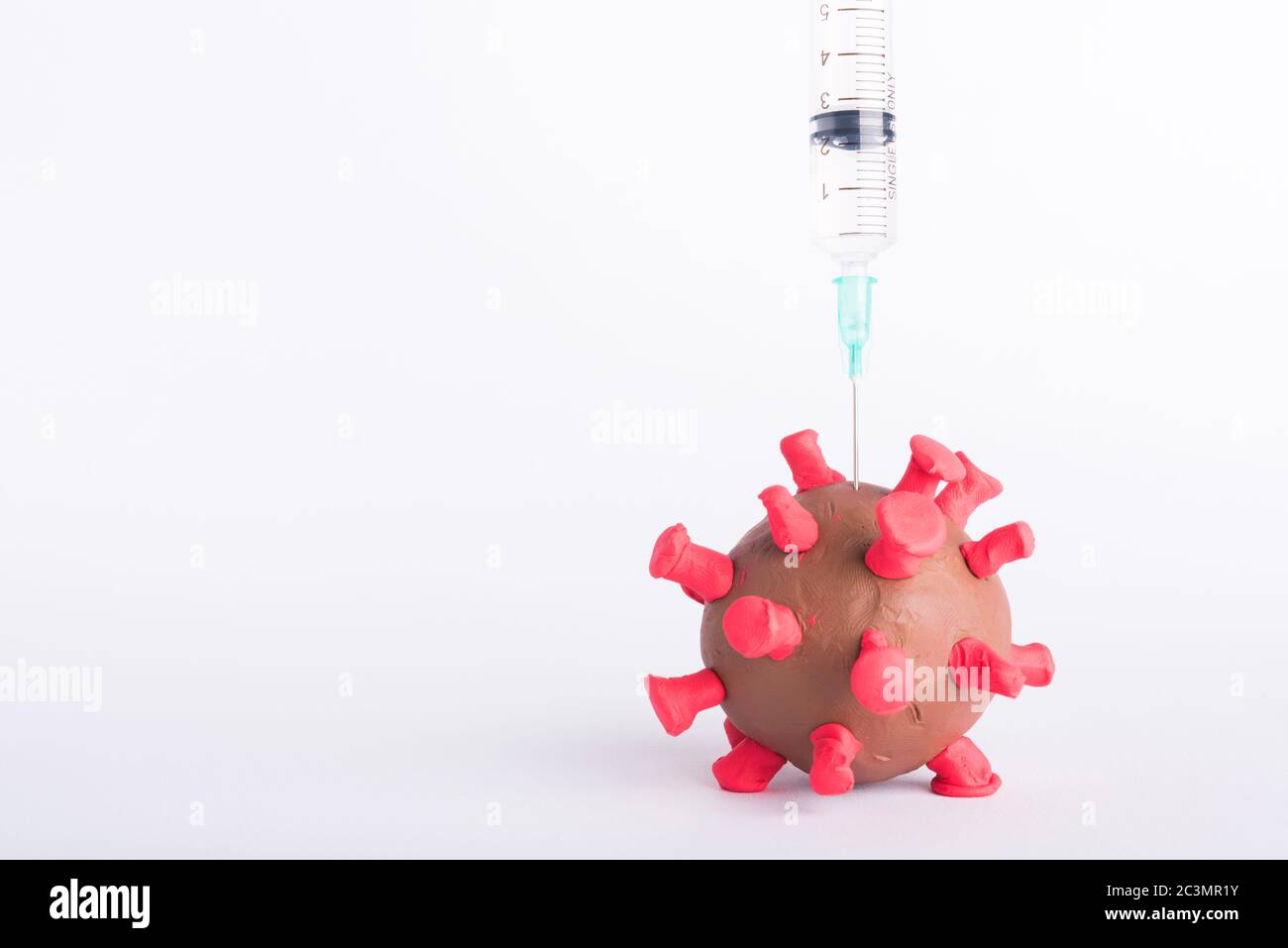 Closeup plasticine disease cells virus bottle vaccine and syringe of ...