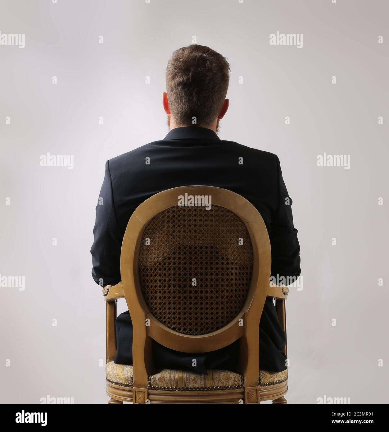 Sitting on chair from behind hi-res stock photography and images - Alamy