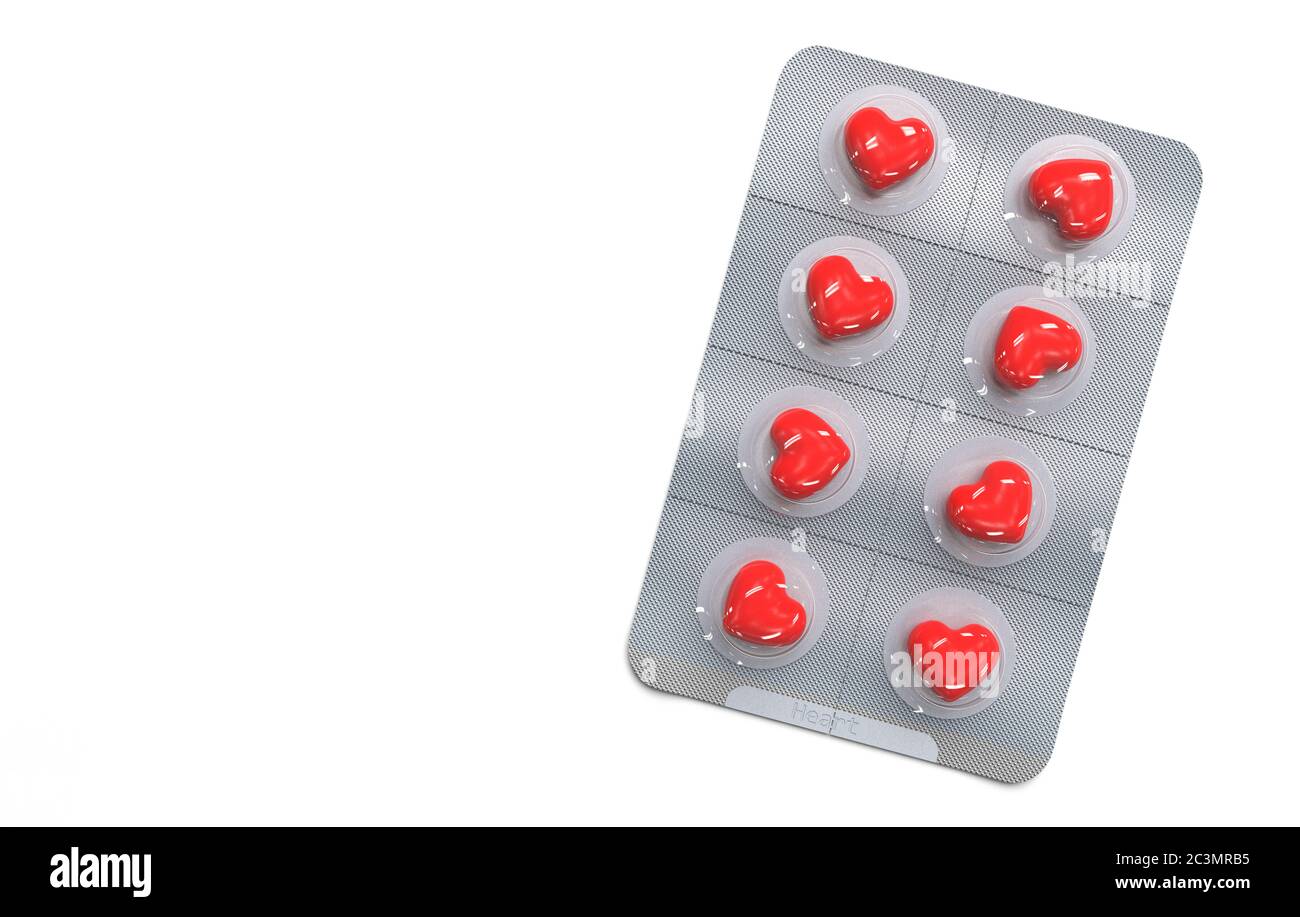 Red pills in the shape of a heart in a blister. Pill packaging on a ...