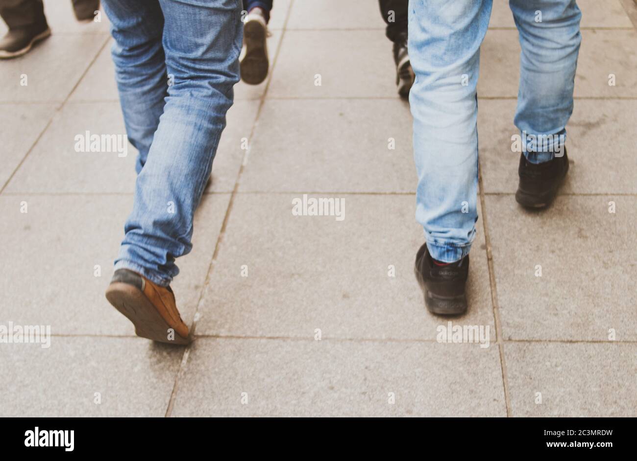 Closeup high angle shot of two males legs walking on a sidewalk Stock ...