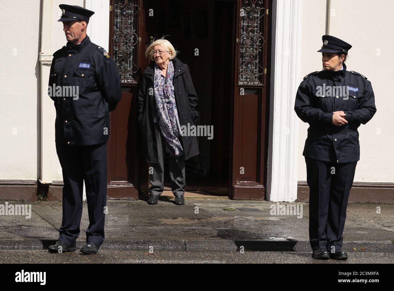 Local residents and Garda before the funeral of Detective Garda Colm ...