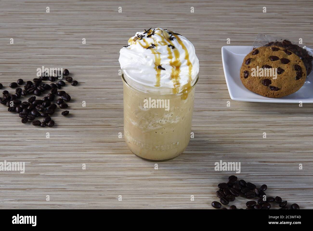Closeup shot of a cold coffee with cream and caramel topping and ...