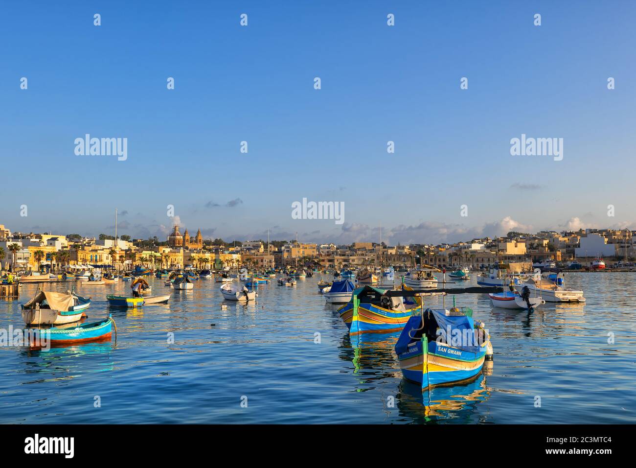 Traditional Maltese Luzzu boats in Marsaxlokk fishing village port on ...