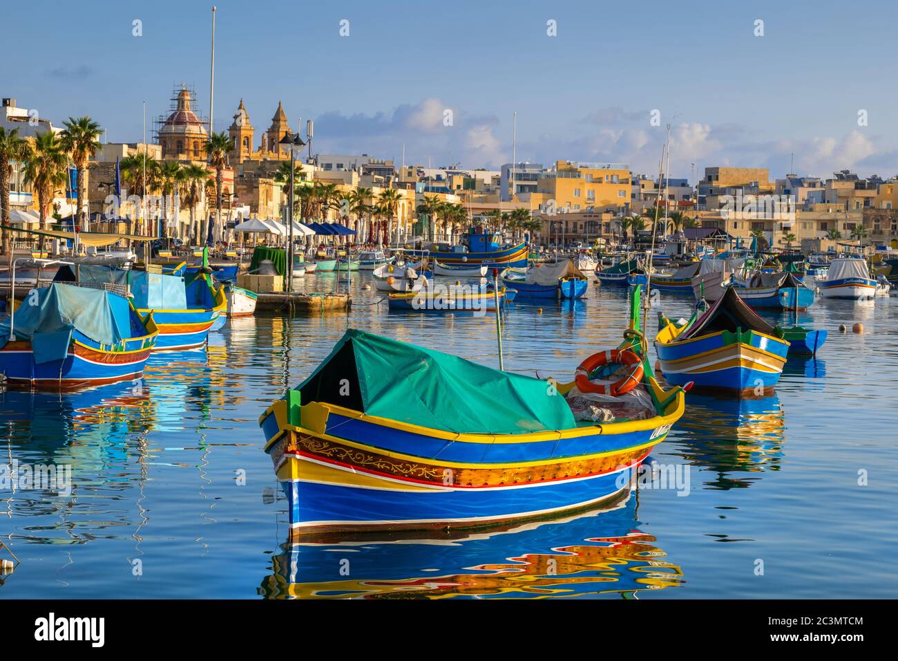 Traditional Maltese Luzzu boats in sea port of Marsaxlokk fishing ...