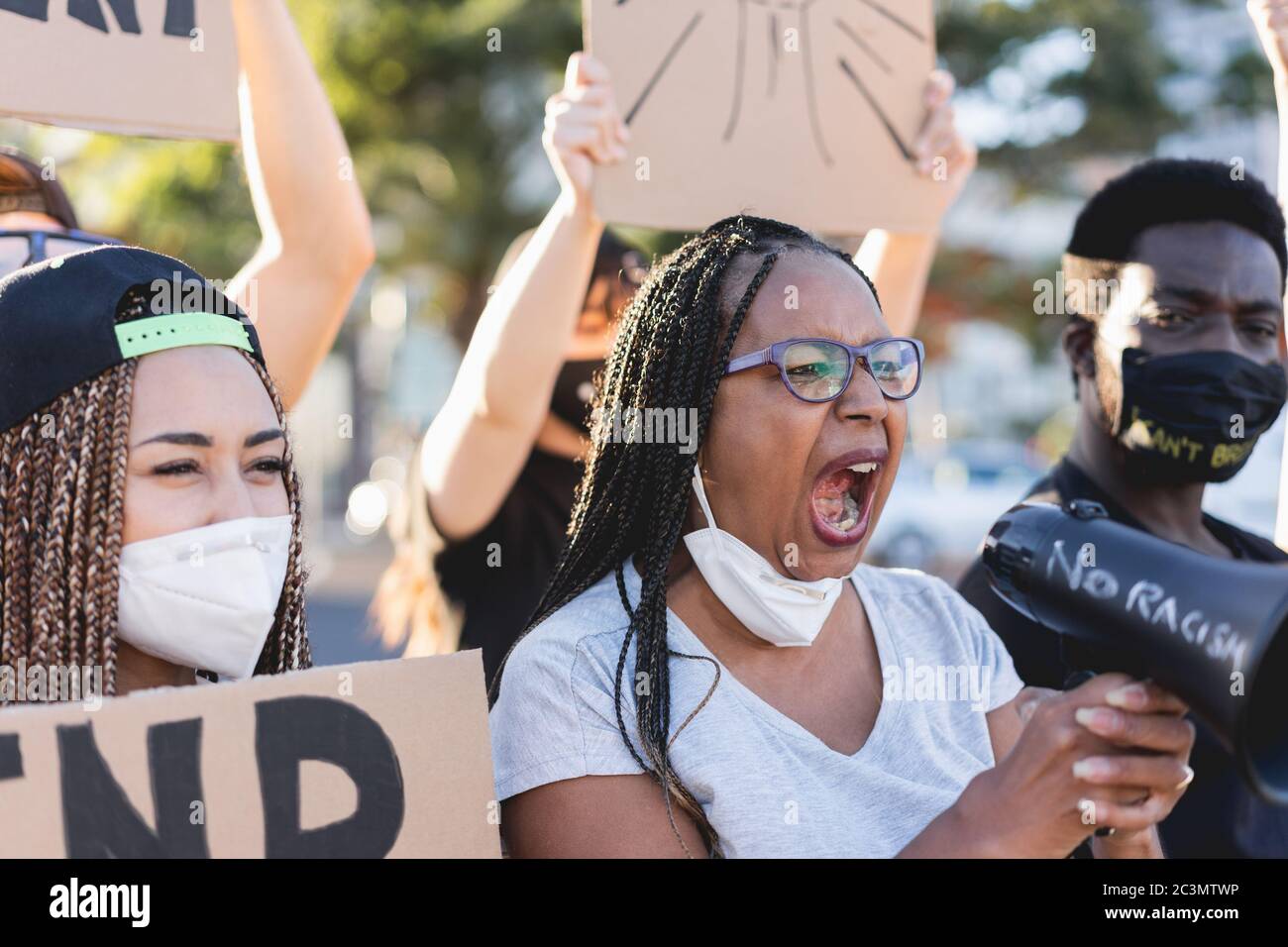Group of people demonstrators protest in city street against racism ...