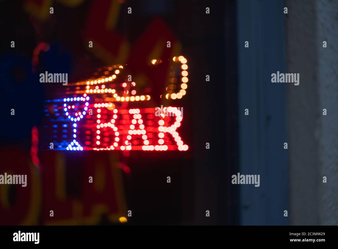 Colorful bright lit sign of a bar at night Stock Photo - Alamy