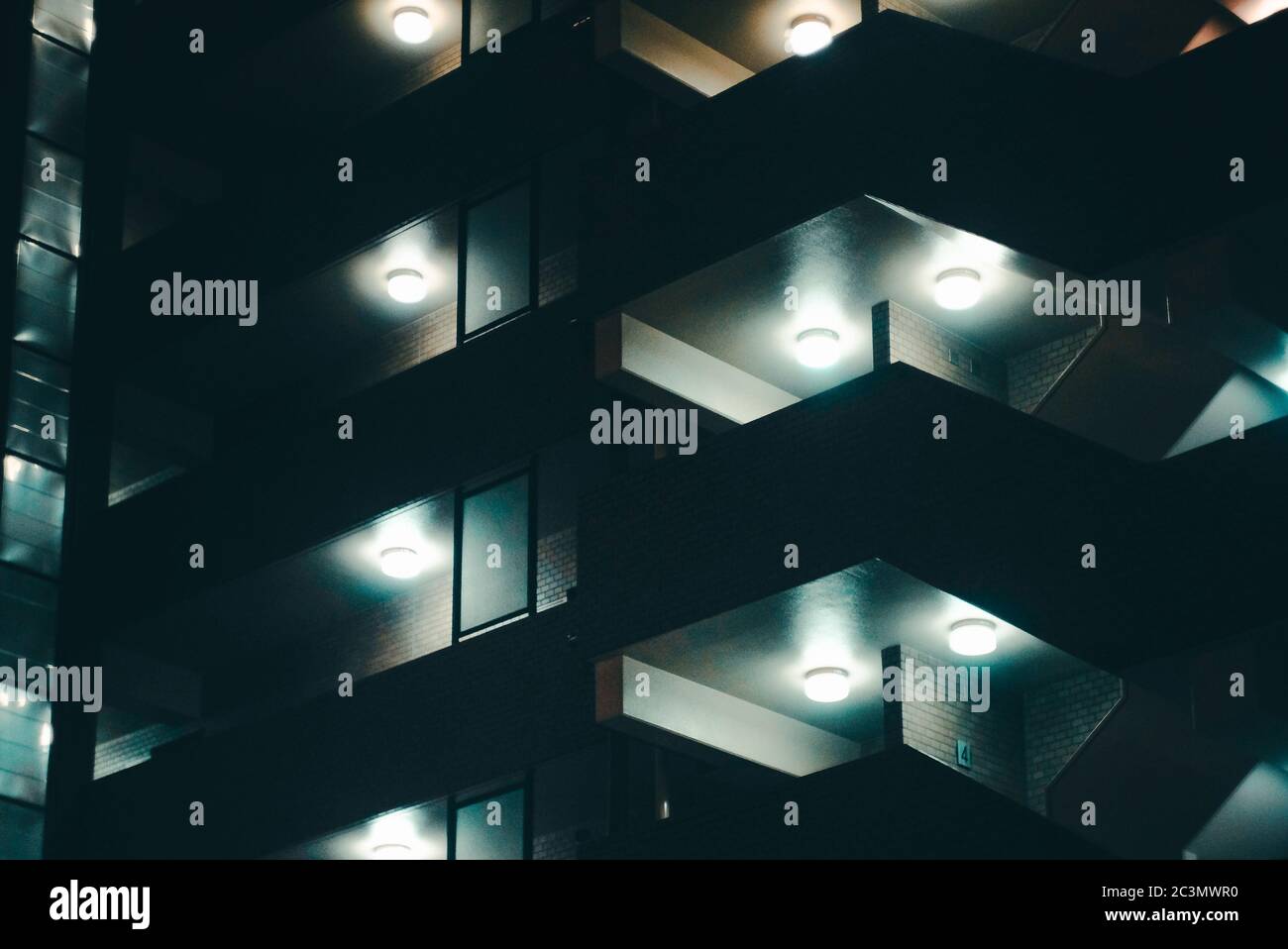 Low angle shot of a modern building with lit bulbs at night Stock Photo ...