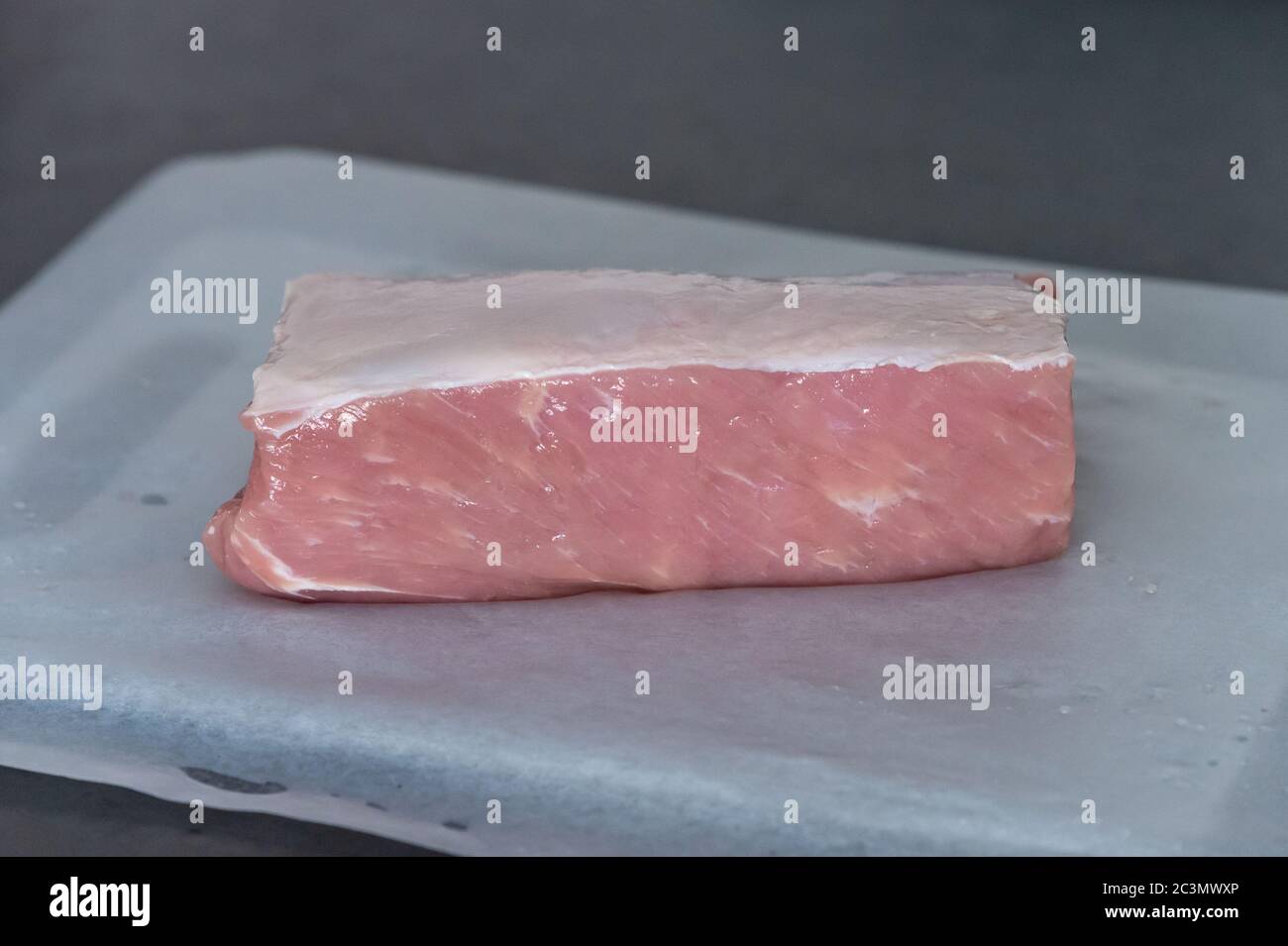 Closeup of a raw meat slab on chopping board Stock Photo - Alamy