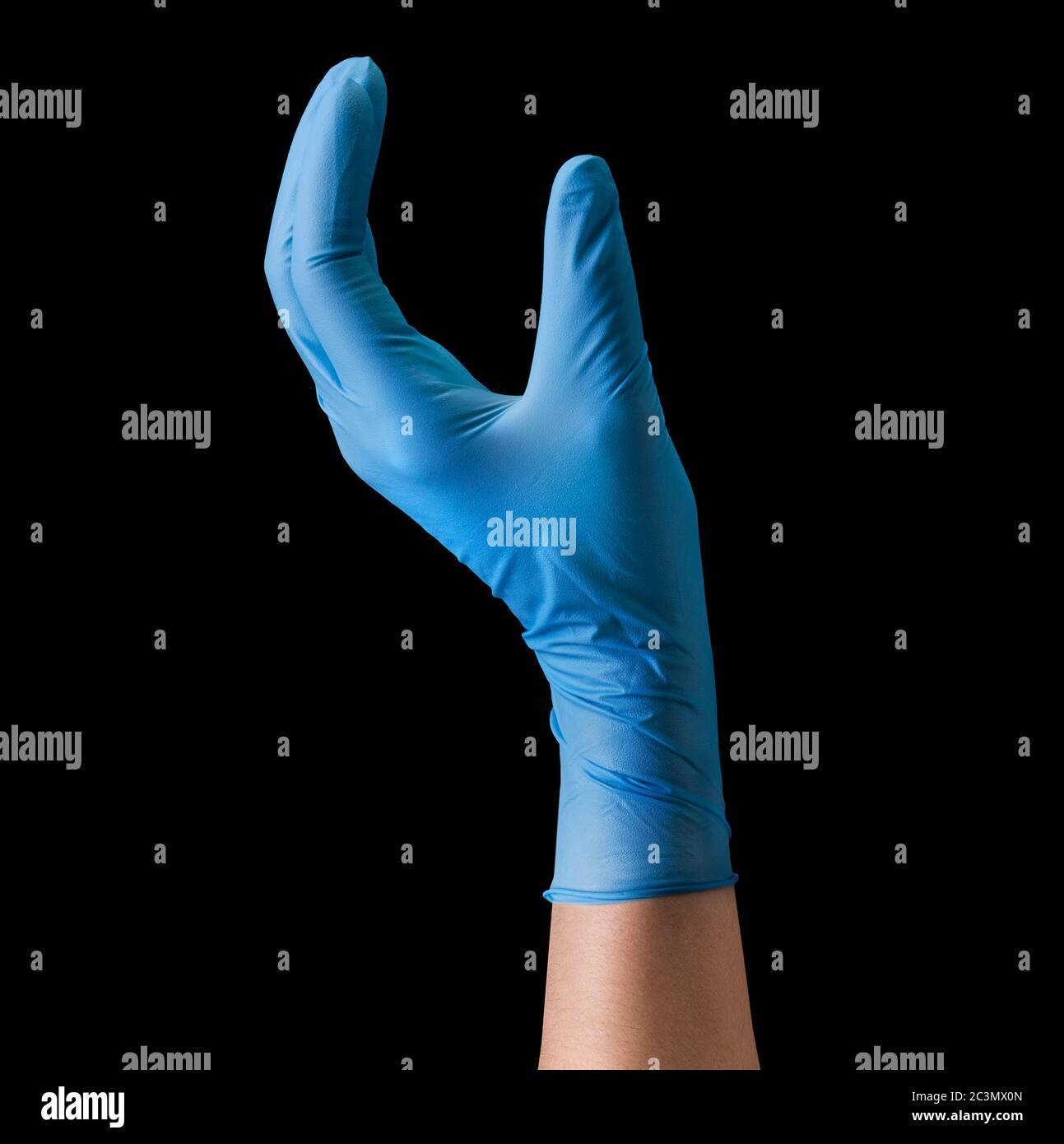 Doctor's hand in medical gloves holding something with two fingers ...