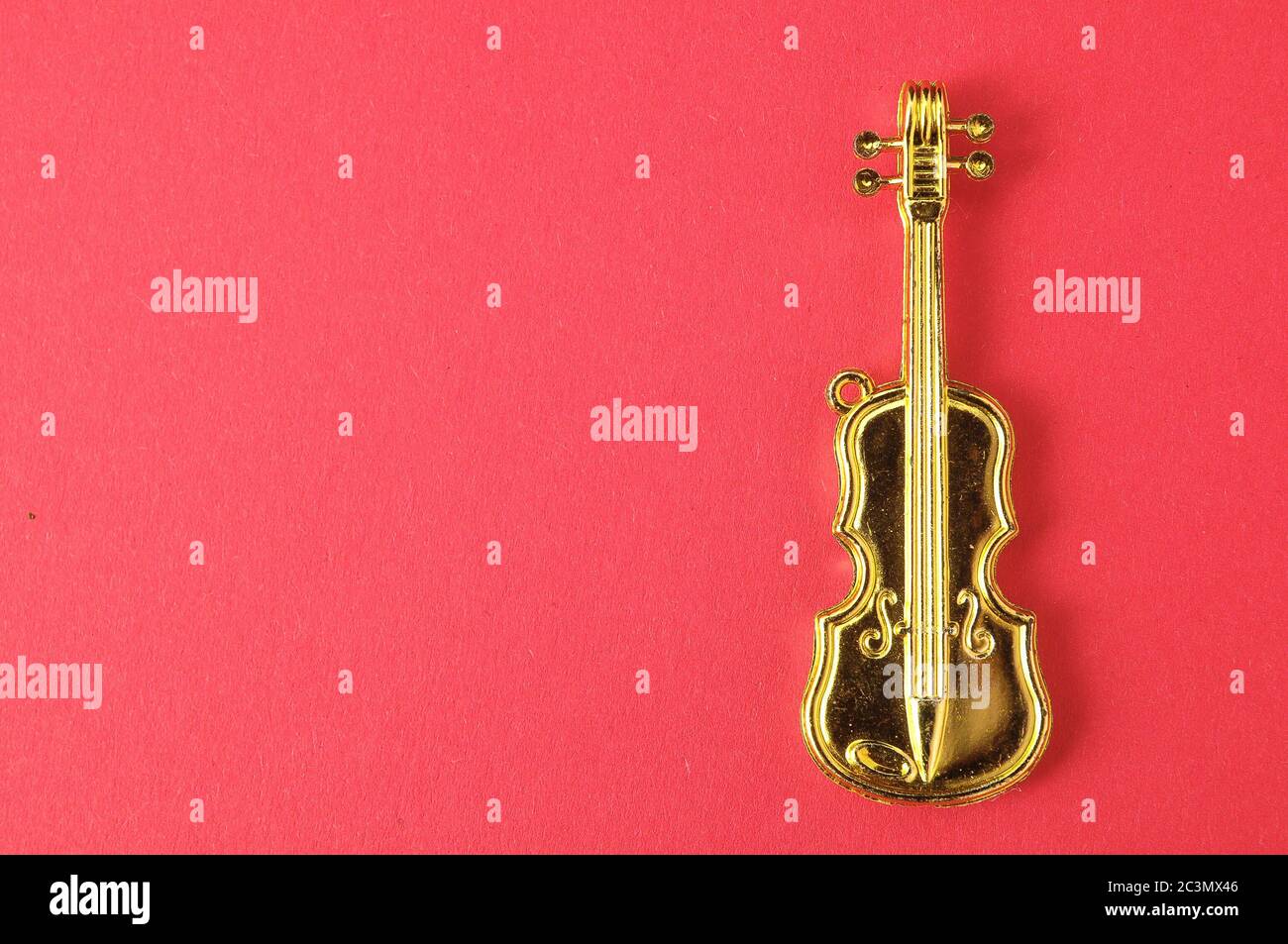 Gold Violin Instrument Figurine on a Colored Background Stock Photo - Alamy