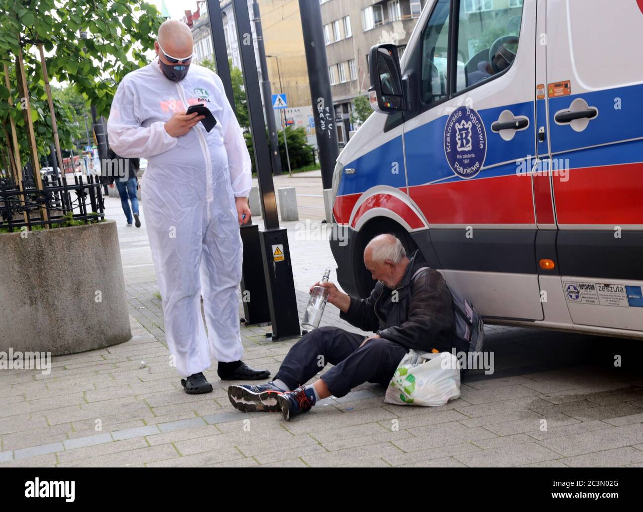 Cracow. Krakow. Poland. A paramedic and drunk man with the bottle of ...