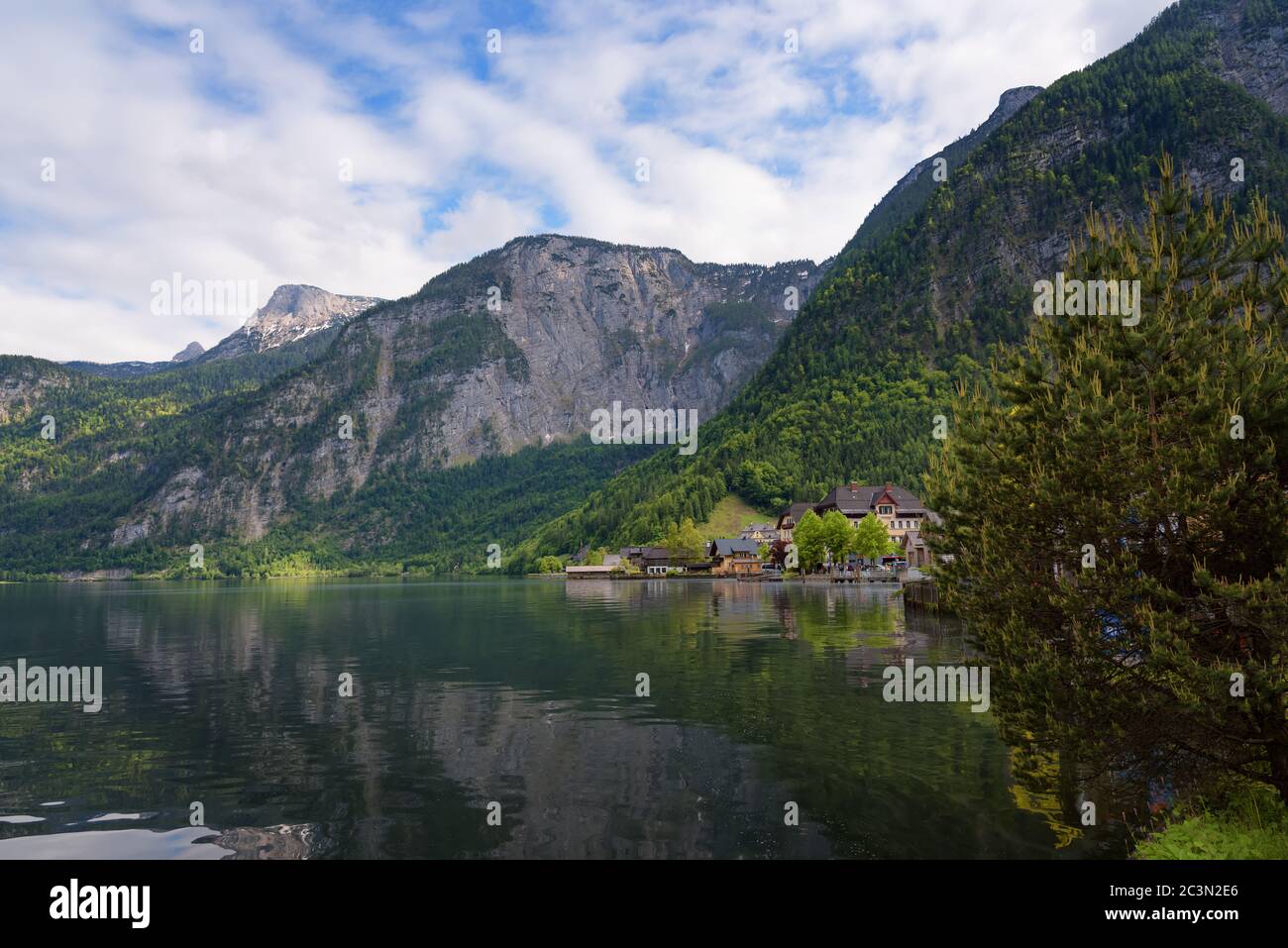 Scenic picture-postcard view of traditional old wooden houses in famous Hallstatt mountain ...