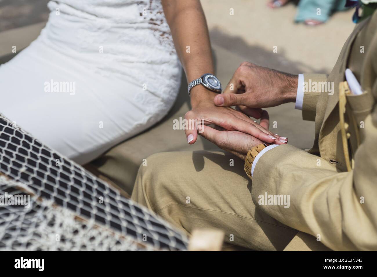 Horizontal shot of a groom touching the bride's hand Stock Photo - Alamy
