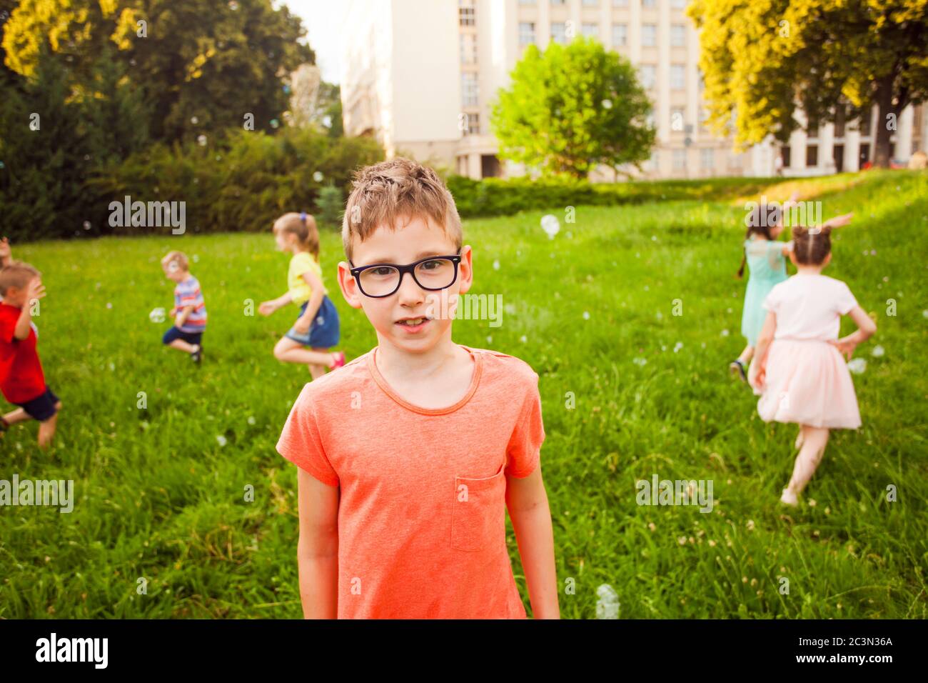Little boy is trying to make friends with stranger kids Stock Photo - Alamy