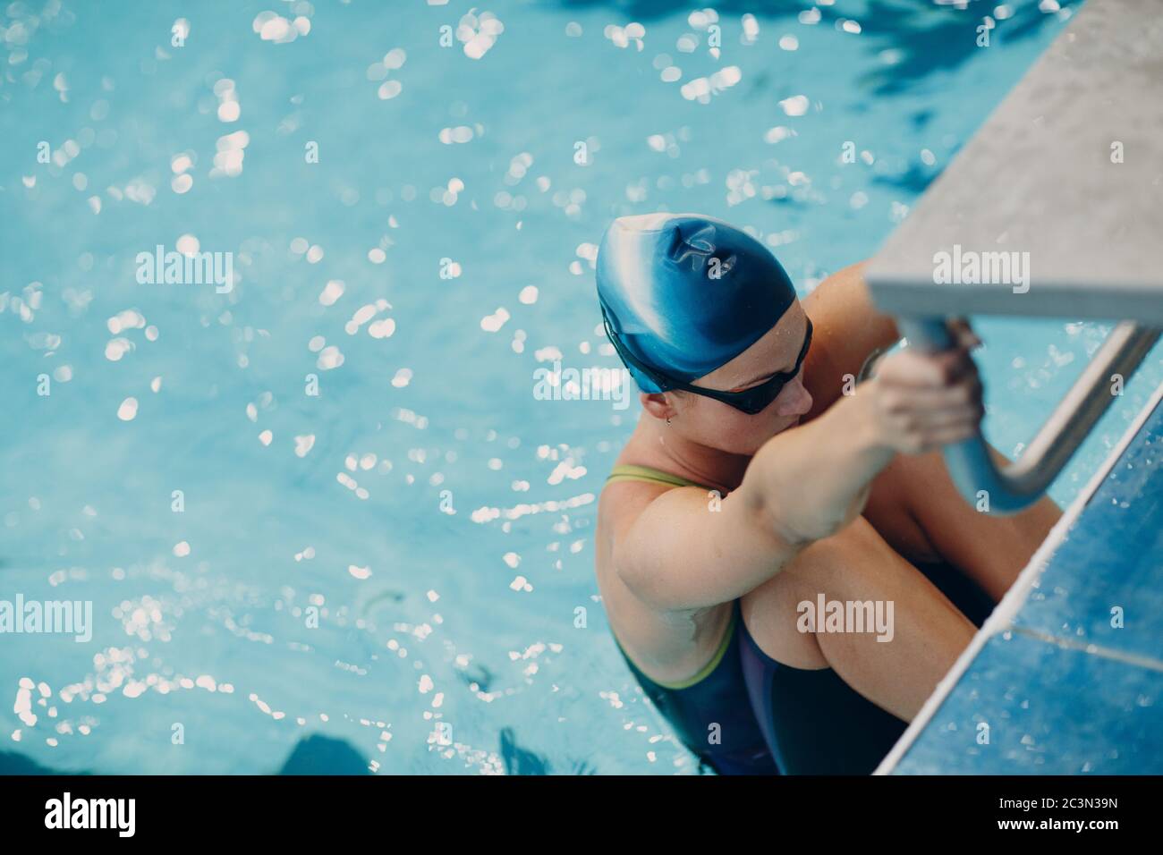 Young woman swimmer going to swim in swimming pool Stock Photo - Alamy
