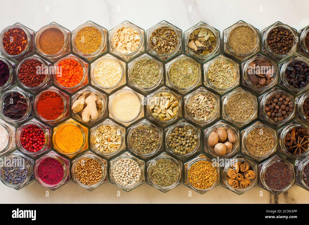 Assorted spices pattern top view in hexagon bottles in the kitchen ...