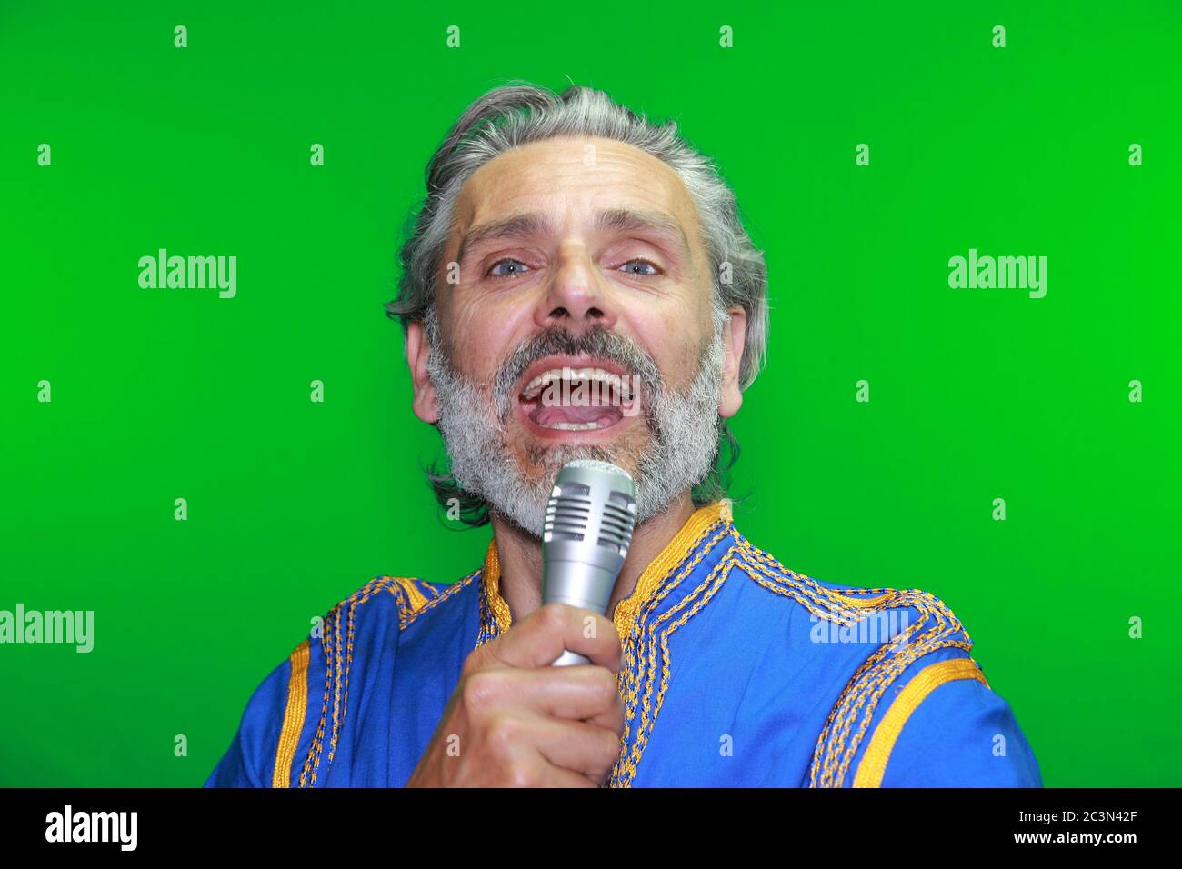 mature man in traditional costume singing over green screen Stock Photo ...