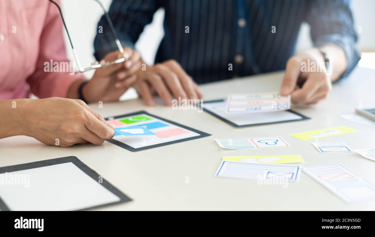 Graphic designers team work together with UX UI designer planning ...