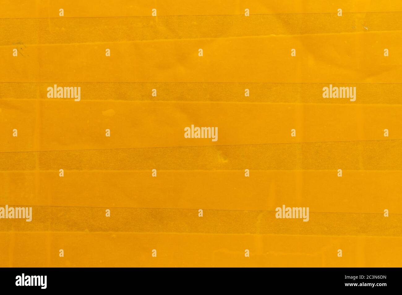 yellow sticky tape wrapped flat surface texture and close-up background ...