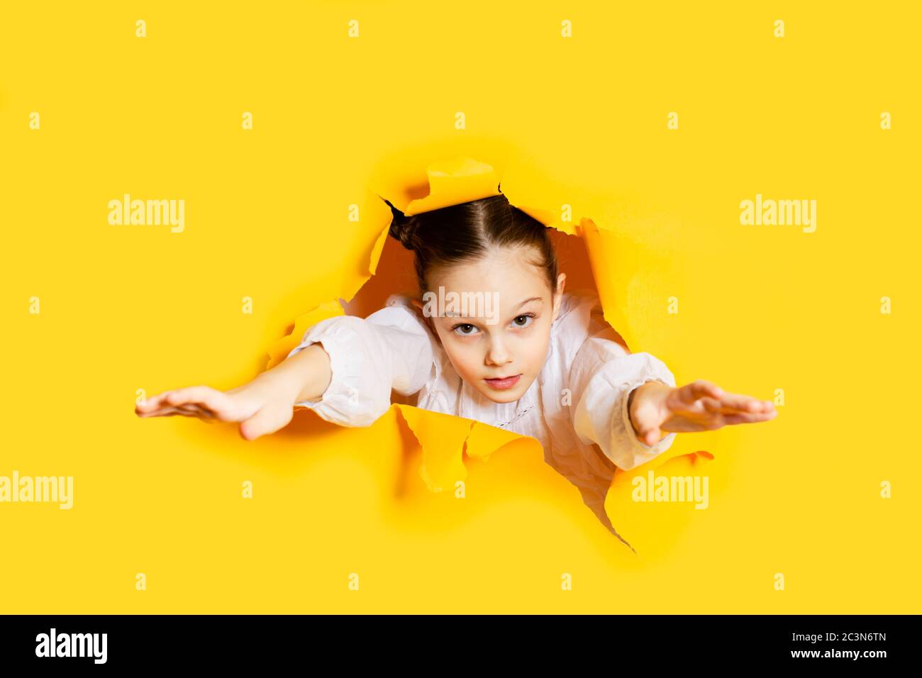 Girl breaking through paper wall. Unticipated release Stock Photo - Alamy