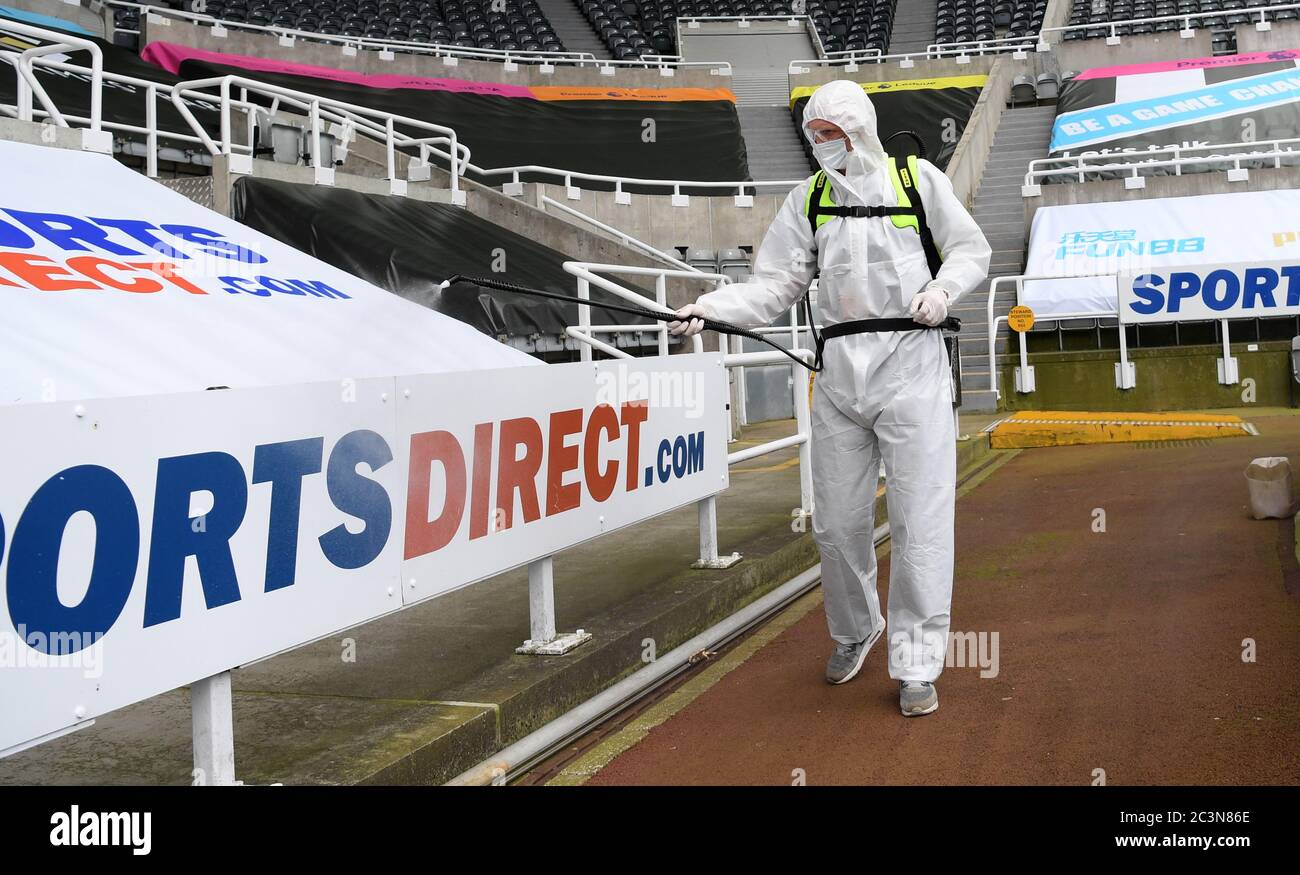 Ad boards are disinfected during the Premier League match at St James ...