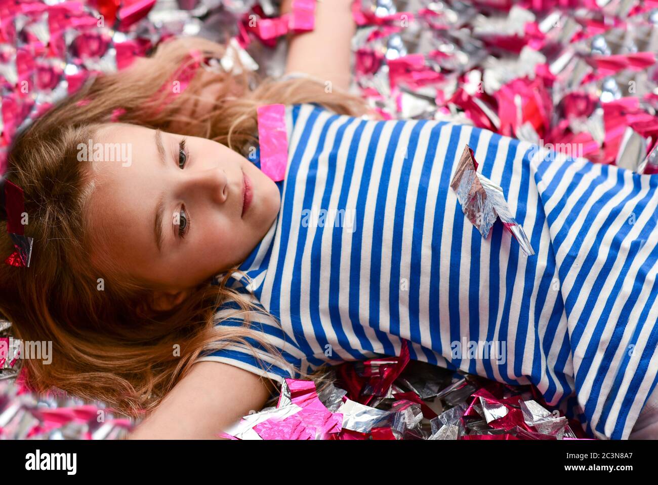 Child girl lies on candy at the party and is sad Stock Photo - Alamy