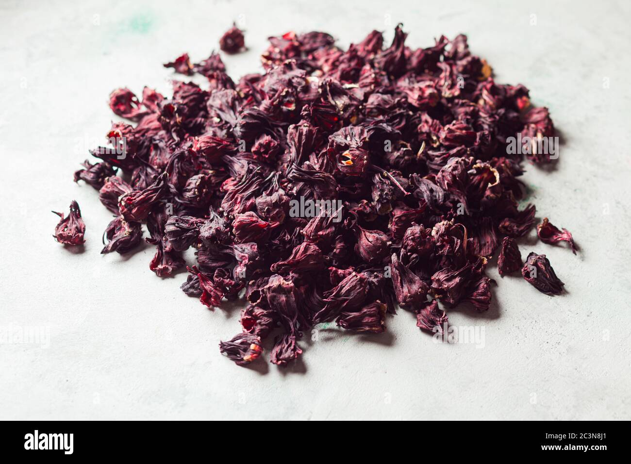 The dried karkade flowers on a white background Stock Photo - Alamy
