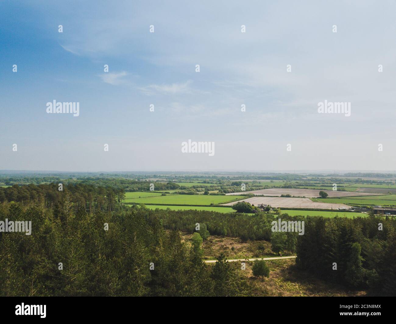 Horizontal shot of a landscape with dense forests and flat fields under ...