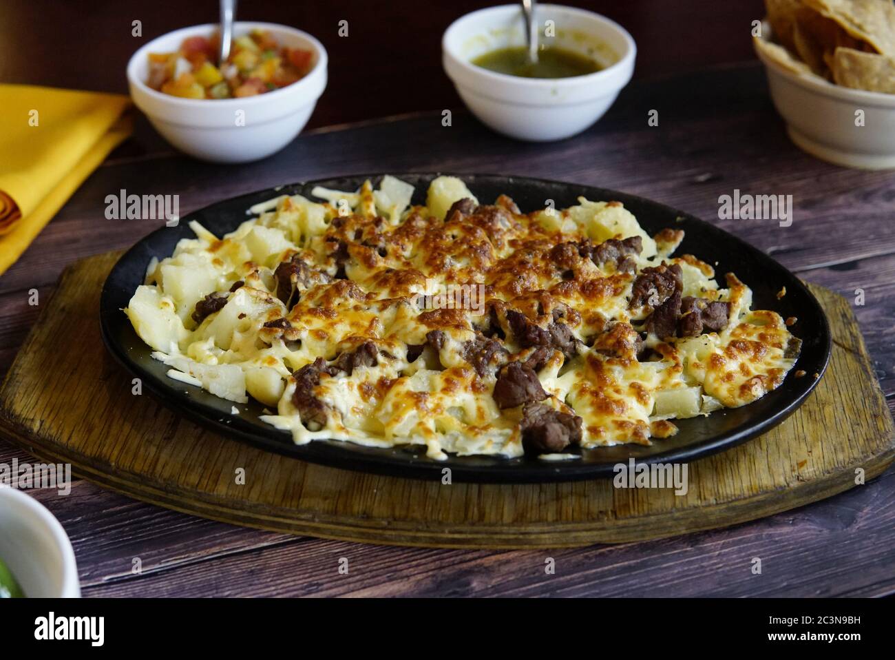 High angle closeup shot of a tasty dish with melted cheese on top on a ...