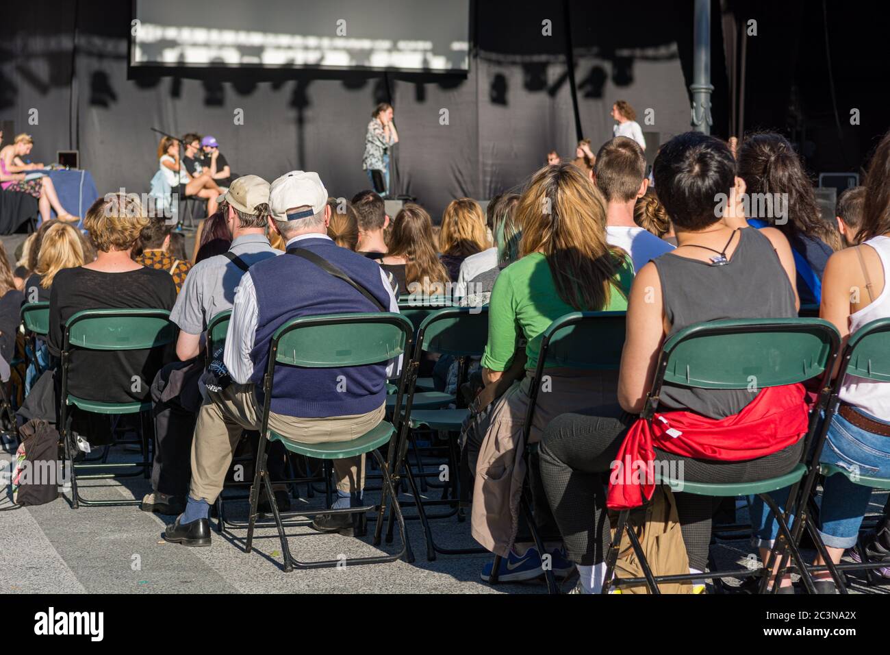 Rear view of audience at open air theatre in city center Stock Photo ...